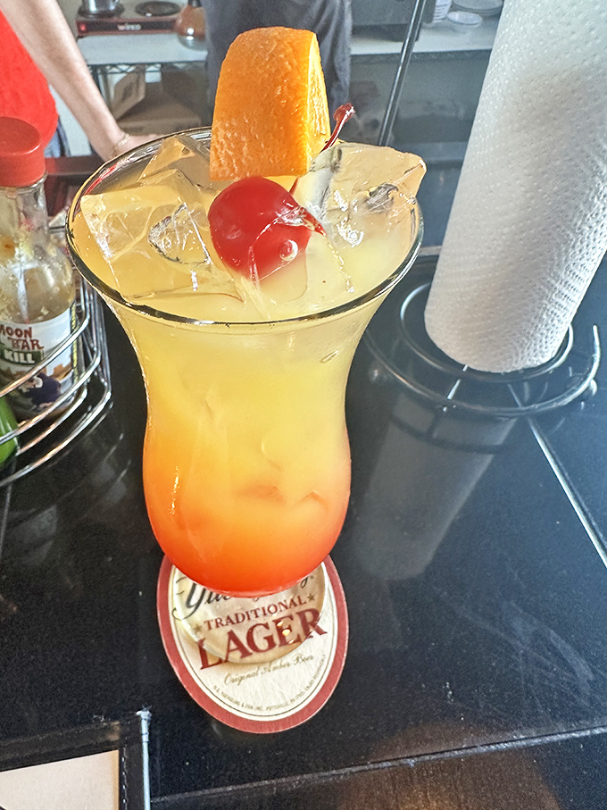 This sunrise-in-a-glass cocktail isn't just a drink; it's vacation vibes in liquid form, complete with that perfect cherry on top.