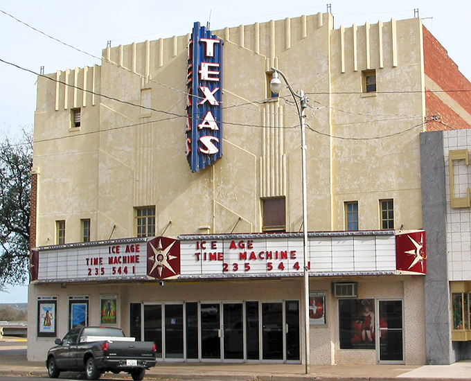 The Texas Theatre's vintage marquee glows with promise, a reminder of when going to the movies was an event, not just something to do while scrolling.
