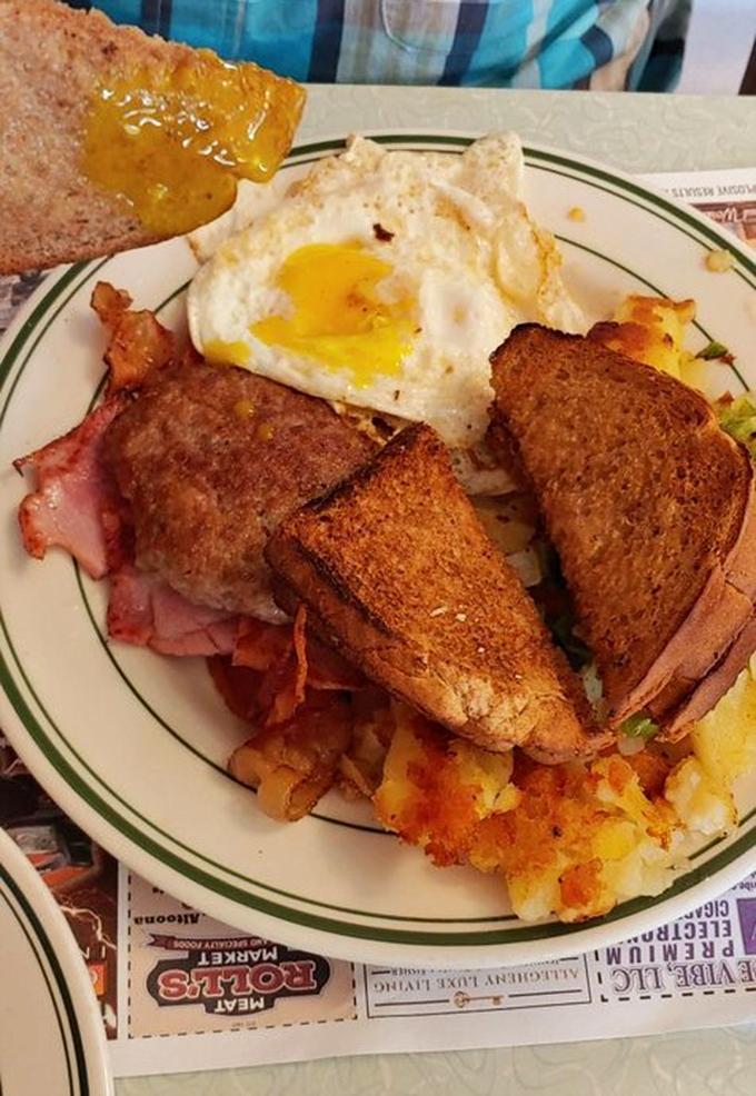 A breakfast sandwich, home fries, and that perfectly cooked egg—this plate doesn't need filters or fancy descriptions, just a hungry human and a fork.