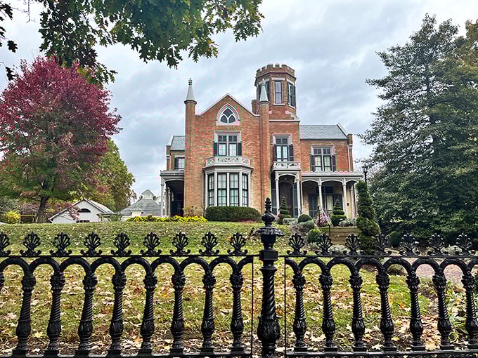 Behind that ornate iron fence sits The Castle, where Victorian splendor meets Midwestern practicality in a delightful architectural tango.