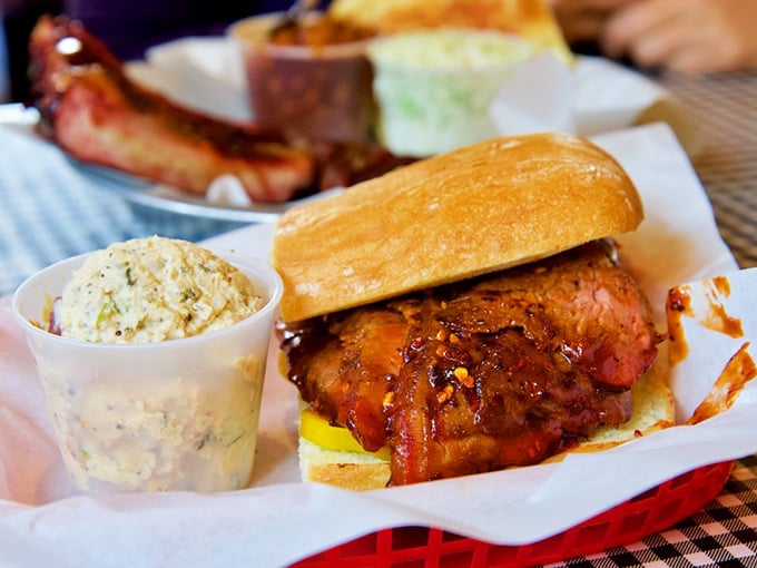 Sandwich architecture that deserves its own blueprint. Sauce-glazed meat nestled in a golden bun with creamy slaw standing by for textural relief.