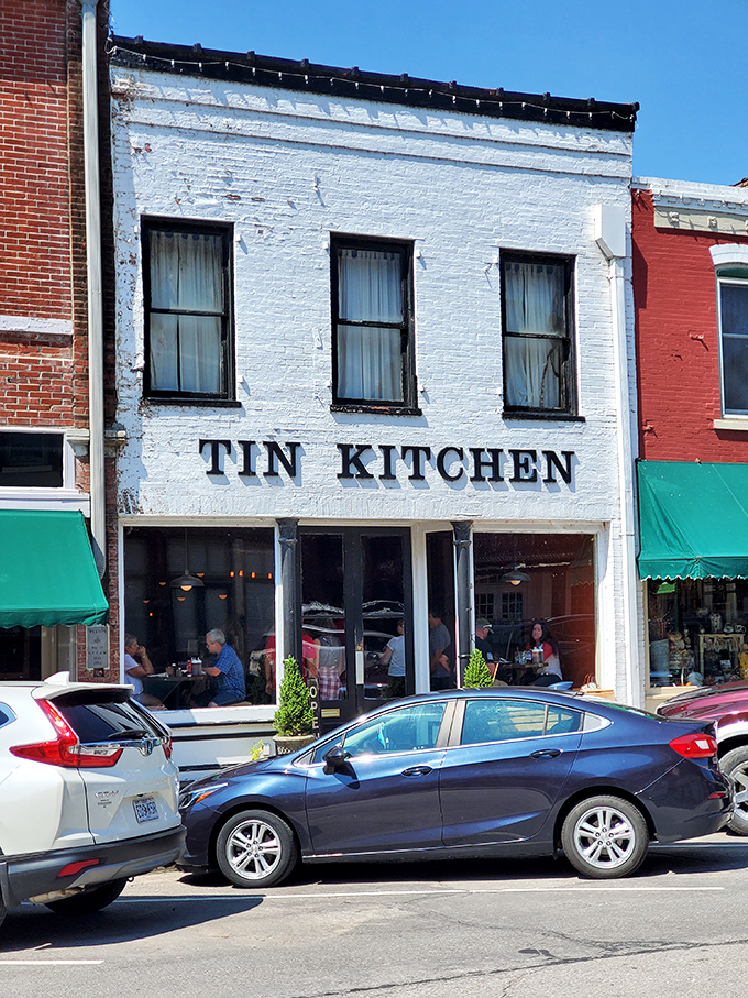 Tin Kitchen's weathered white facade houses culinary magic that would make your grandmother simultaneously proud and a little jealous.
