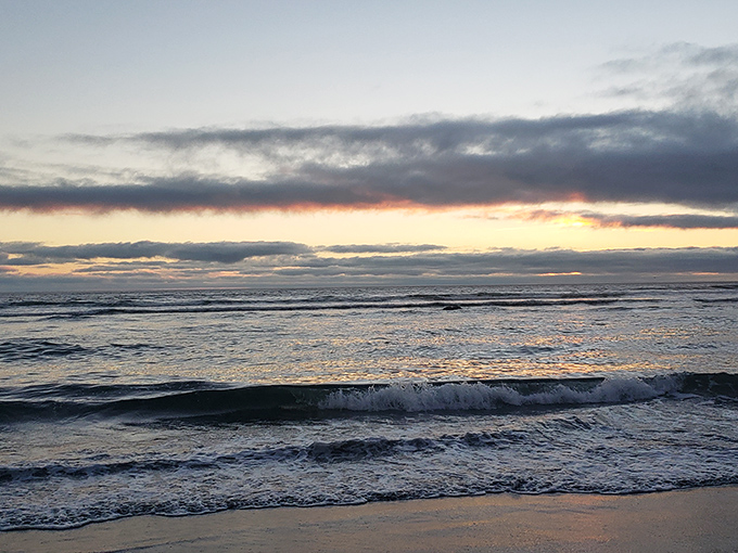 Sunset transforms the Pacific into liquid gold, with waves providing the soundtrack to nature's most reliable light show.