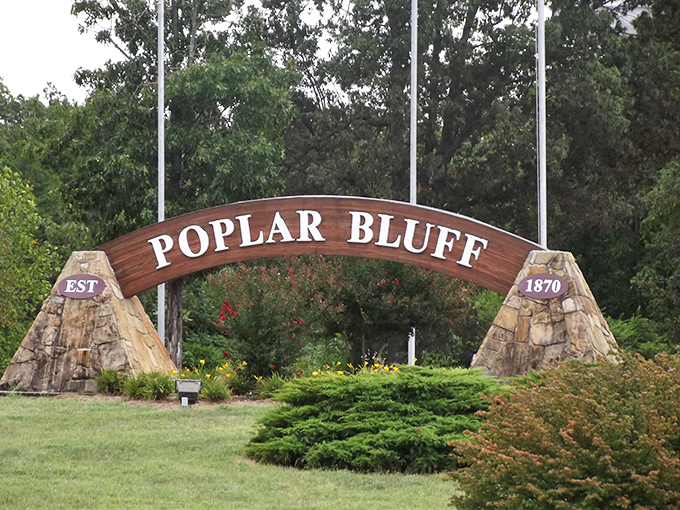 "EST 1870" &ndash; Poplar Bluff's welcome sign anchored by natural stone pillars greets visitors with Midwestern warmth and historical pride.