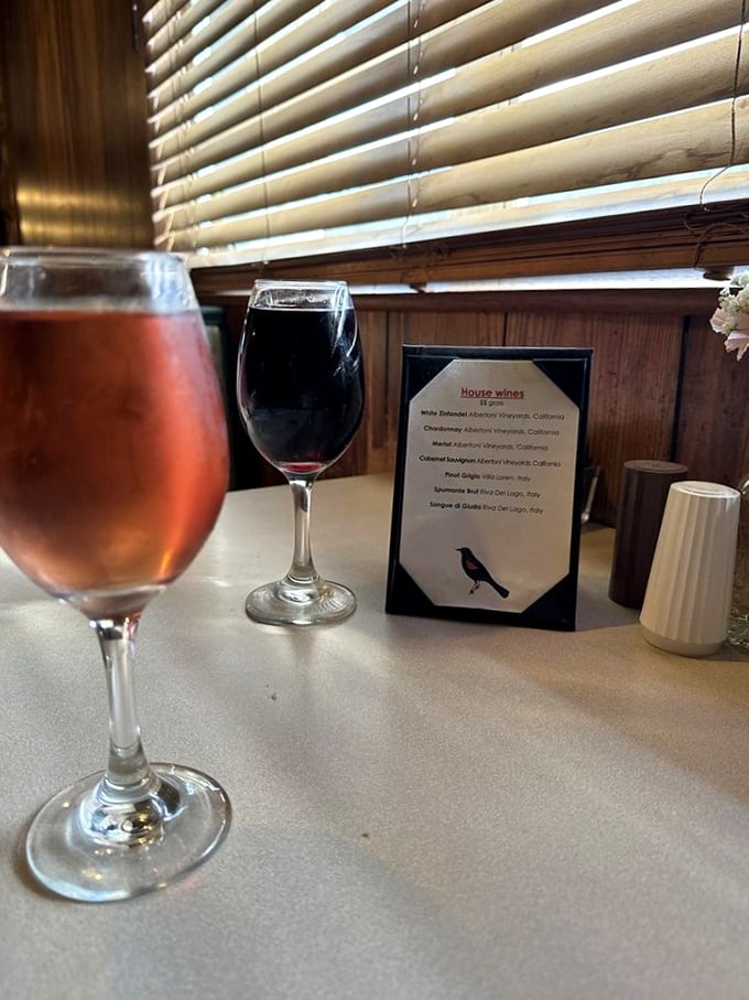 Wine glasses catching the light like liquid jewels &ndash; proof that even in hunting lodge surroundings, civilized pleasures aren't forgotten.