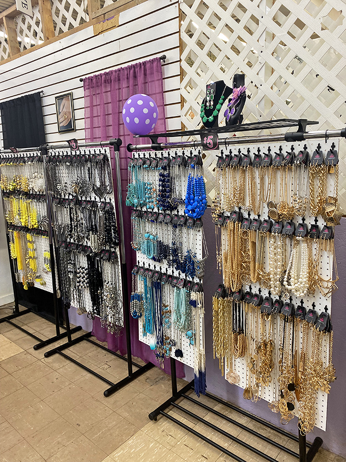 Costume jewelry sparkles under the lights, arranged by color like a fashionable rainbow where $20 can make you feel like royalty.
