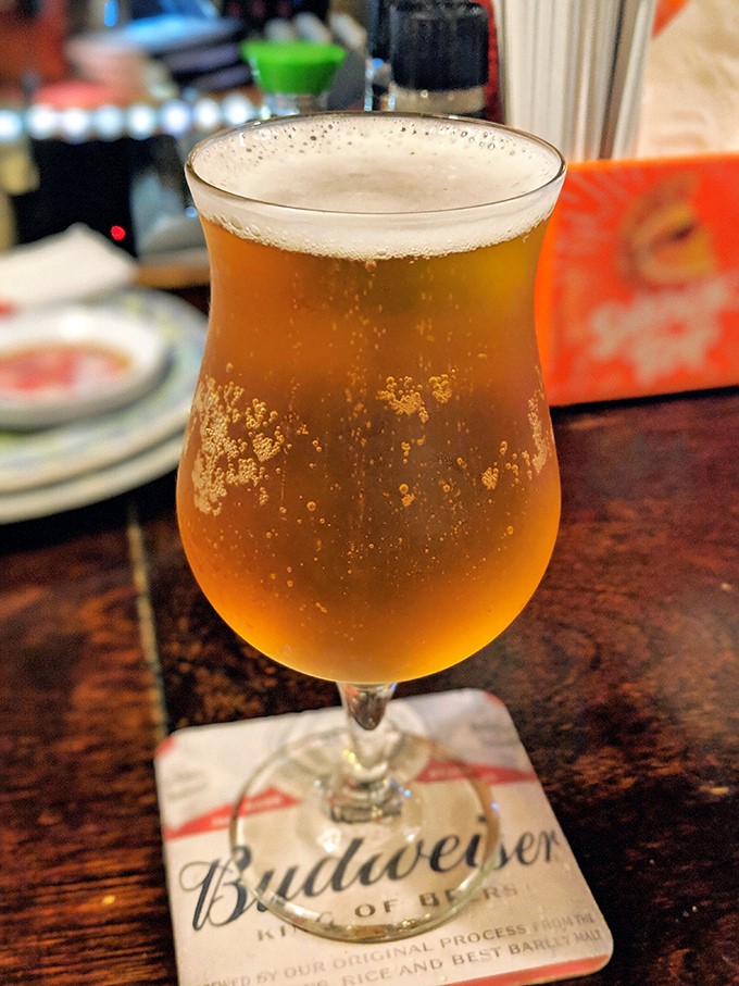 A perfectly poured beer on a Budweiser coaster&mdash;sometimes the simplest pleasures are the most reliable companions to seafood feasts.