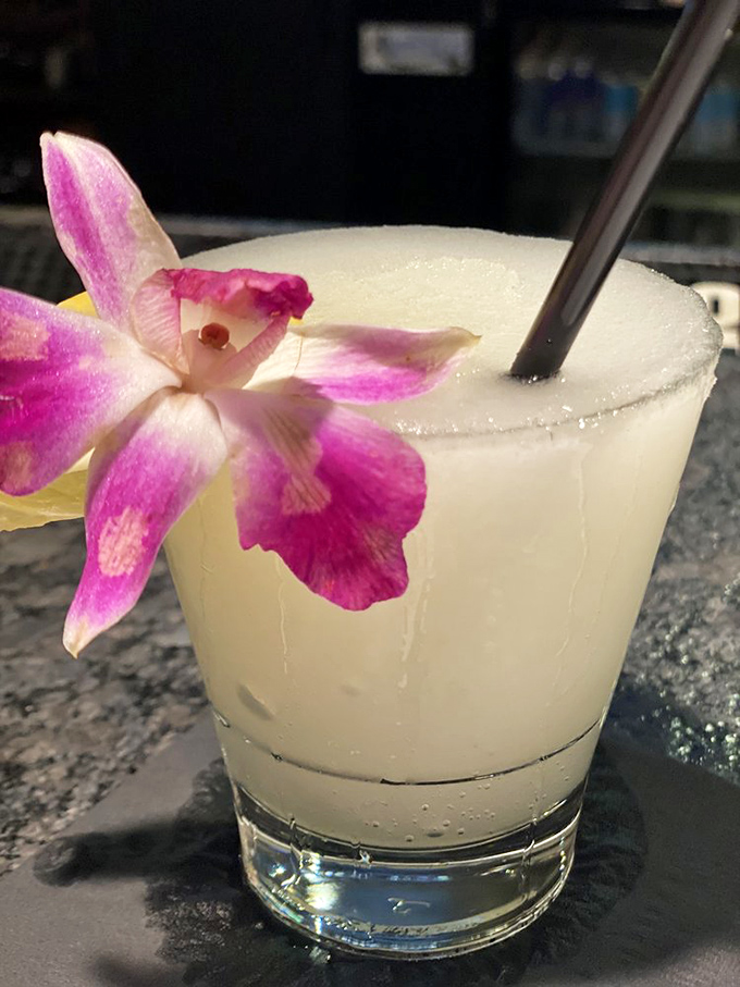Not just a drink, but a vacation in a glass. That orchid garnish isn't showing off&mdash;it's celebrating what's in the cup.