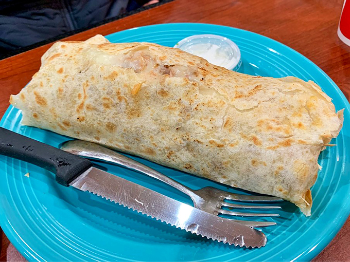 This isn't just a burrito—it's a tightly wrapped bundle of joy that requires a knife, fork, and absolutely zero shame about the inevitable food coma.