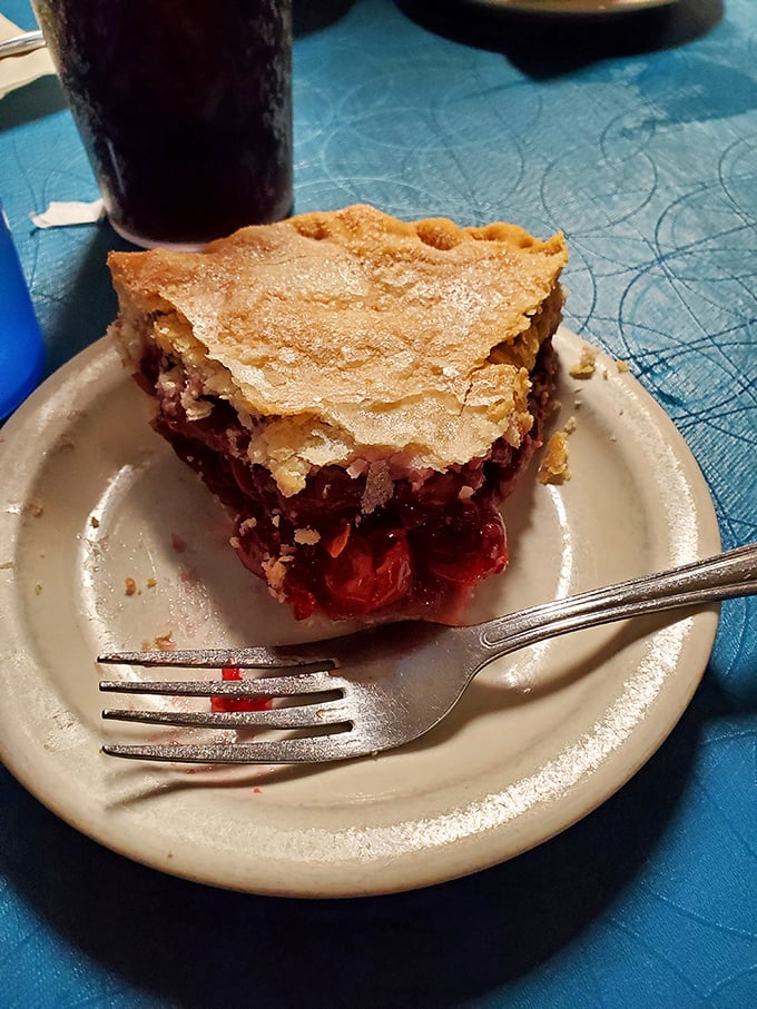 Cherry pie that strikes the perfect balance between sweet and tart, with a golden crust that shatters just right. The fork marks tell the real story &ndash; resistance is futile.