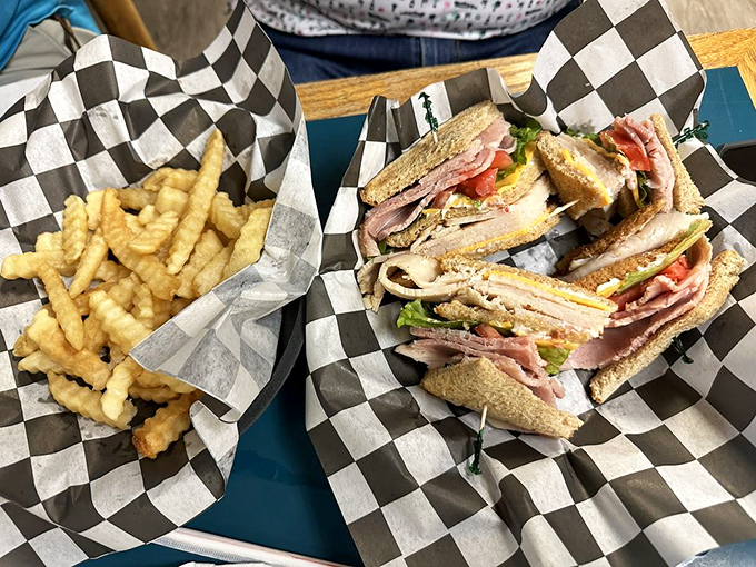 The club sandwich—the triple crown of lunch options. Stacked higher than the Derby purse with crispy fries that deserve their own photo finish.