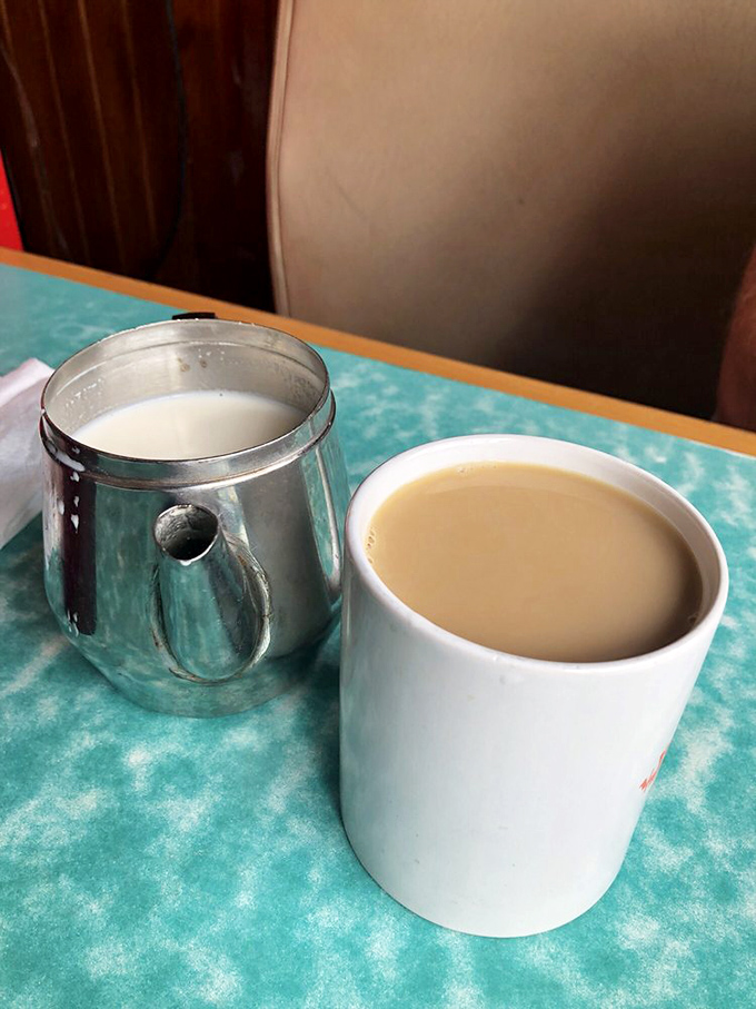 The humble coffee setup&mdash;metal creamer and sturdy mug&mdash;promises unlimited refills and unlimited possibilities for the day ahead.