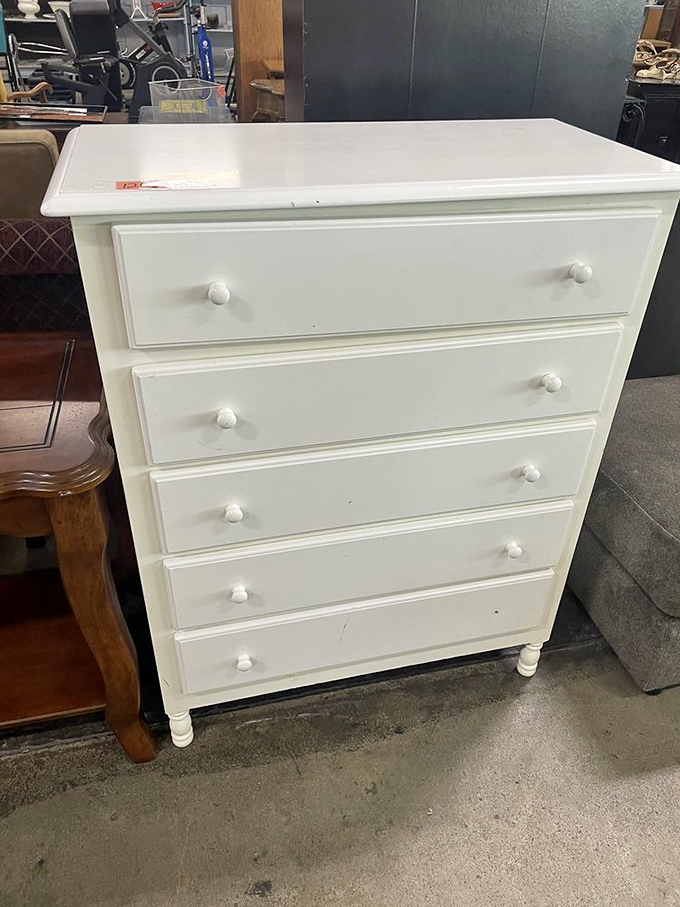 This pristine white dresser waits patiently to organize someone's life with classic charm and practical storage.
