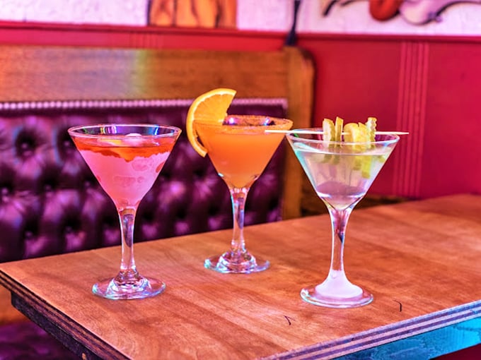 Cocktails lined up like colorful soldiers ready to battle your sobriety. The martini glass—still making ordinary drinks feel fancy since 1925.