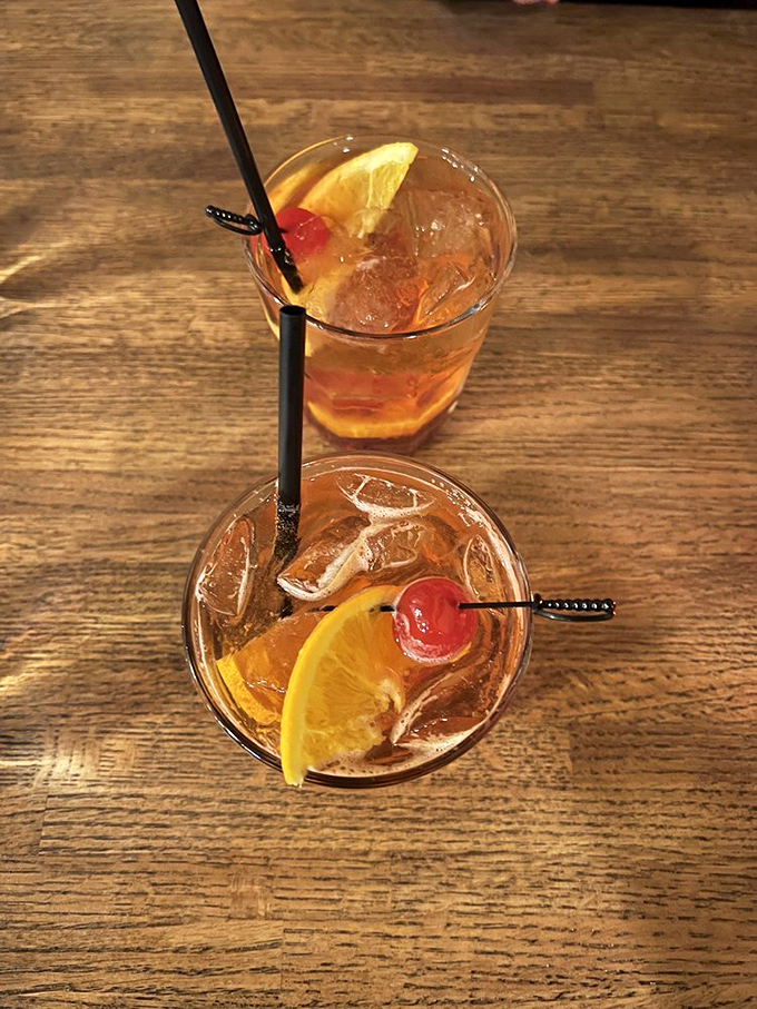 Two Old Fashioneds sit ready for action, their brandy-soaked cherries like rubies waiting to be discovered by Wisconsin's cocktail archaeologists.