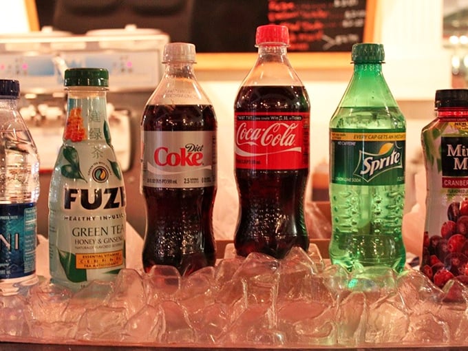 Classic sodas lined up like old friends at a reunion&mdash;each bottle promising the perfect complement to your frozen indulgence.
