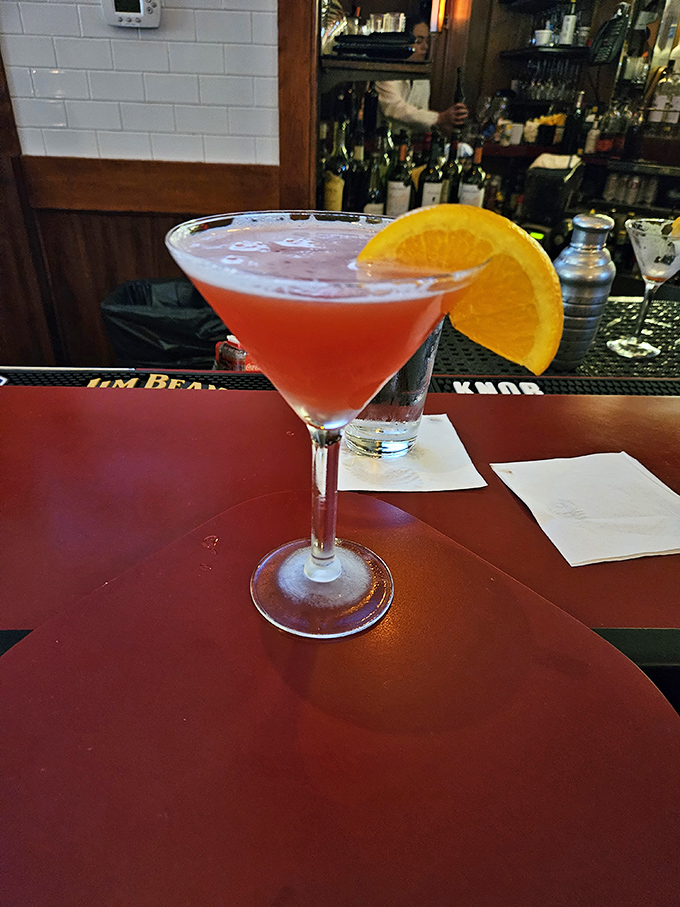A cocktail so photogenic it deserves its own Instagram account, with that orange slice adding a pop of color like a sunset over Lake Michigan.