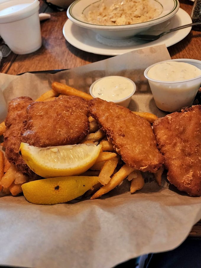 Golden-battered fish that crunches like autumn leaves, served with fries so perfectly crisp they deserve their own fan club.