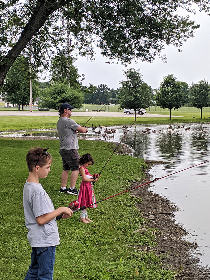 Family fishing at the local pond &ndash; where catching memories often proves more valuable than catching fish, and patience becomes a shared virtue.