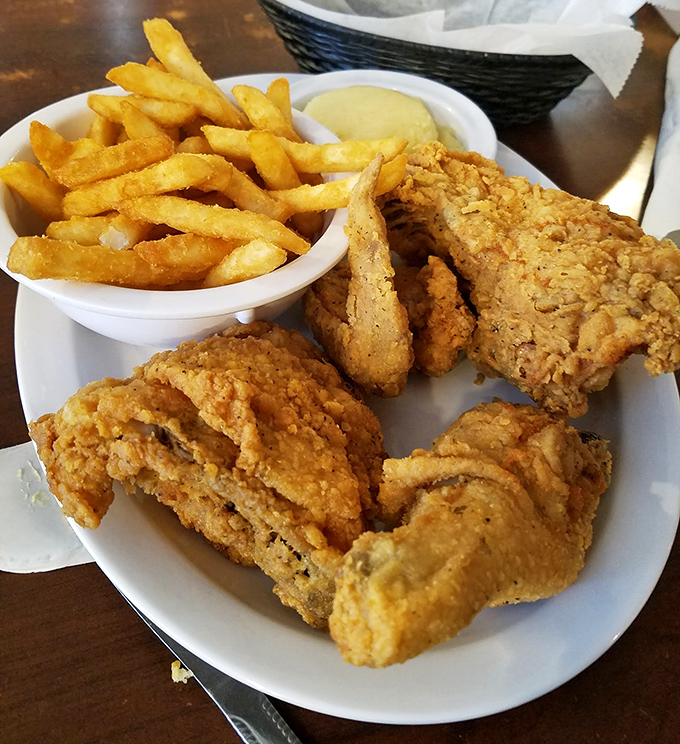 Fried chicken so perfectly golden it deserves its own Instagram filter. Paired with those crispy fries, it's the comfort food equivalent of a standing ovation.
