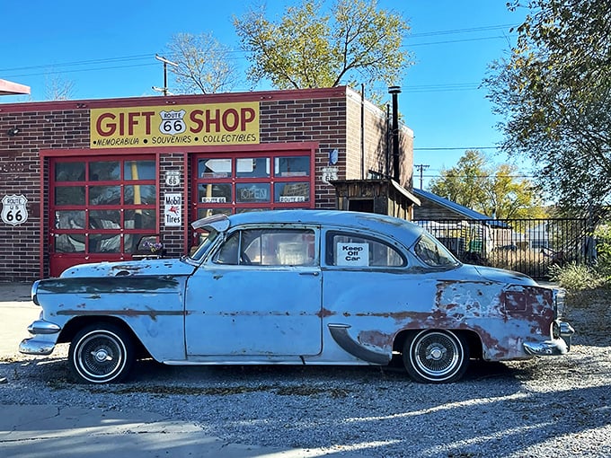 The Route 66 Gift Shop doesn't just sell souvenirs; it sells time travel, with a perfectly weathered Chevy as your temporal tour guide.