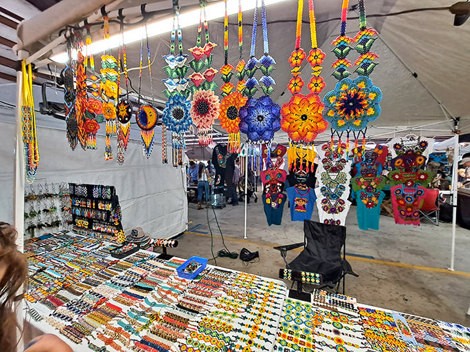 Handcrafted dreamcatchers and jewelry dangle overhead like colorful constellations, each piece representing hours of artisan craftsmanship.