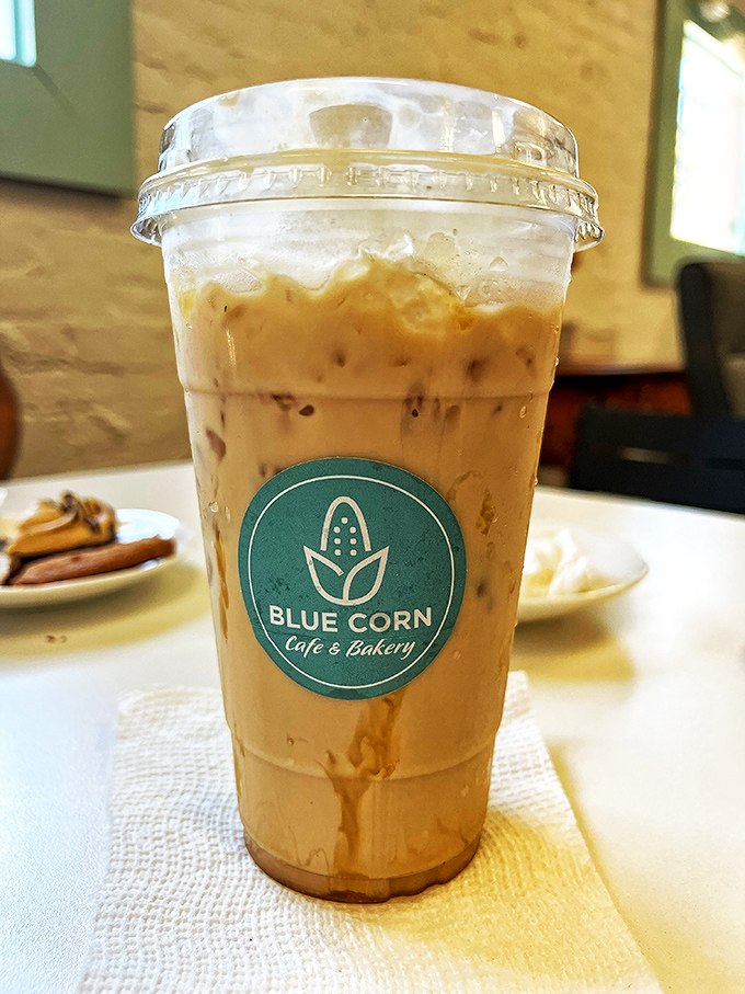 That iced caramel latte isn't just a drink&mdash;it's a portable moment of caffeinated bliss, complete with the cafe's signature turquoise logo.