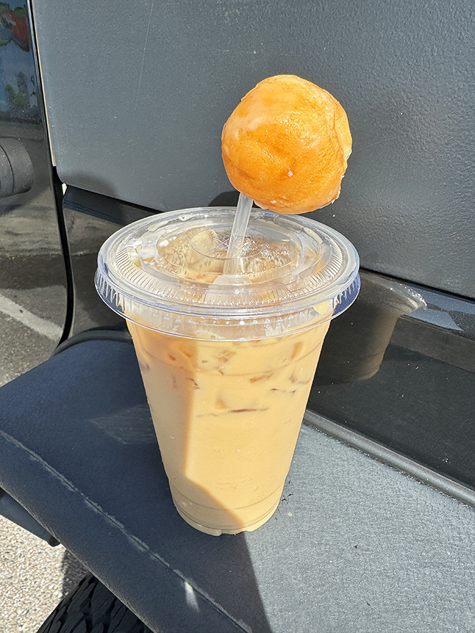 The iced coffee with donut garnish isn't just a beverage&mdash;it's performance art. Caffeination with a side of showmanship.