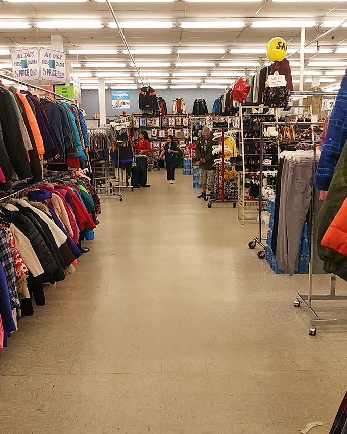 Racks upon racks create a textile landscape where patience is rewarded with unexpected style treasures.