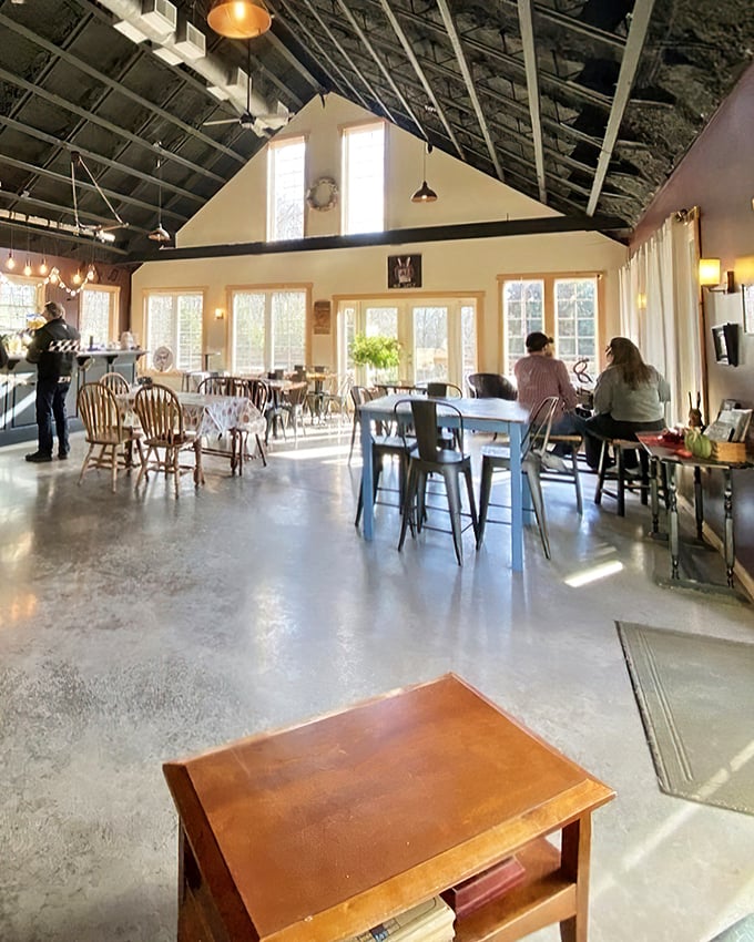 Sunlight streams through tall windows, illuminating a tasting room where mismatched furniture somehow creates the perfect harmony for afternoon sipping.