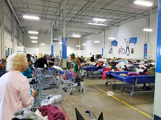 Shoppers engaged in the delicate dance of bin browsing. Notice the strategic cart positioning - these aren't amateurs, folks.