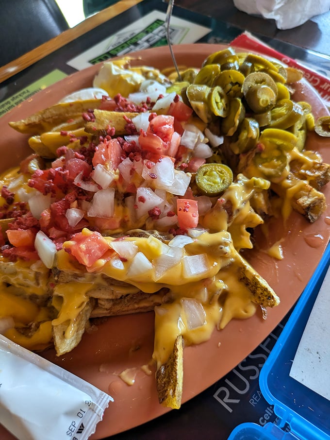 Loaded River Fries&mdash;where potatoes meet their destiny under an avalanche of cheese, bacon, and veggies. Fork required, sharing optional.