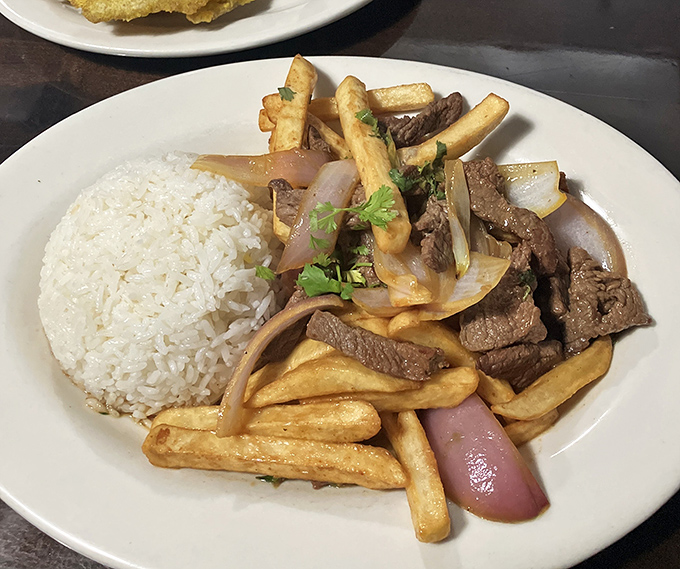 Lomo saltado &ndash; where Chinese stir-fry technique meets Peruvian ingredients. Those french fries aren't a side dish; they're part of the magnificent main event.
