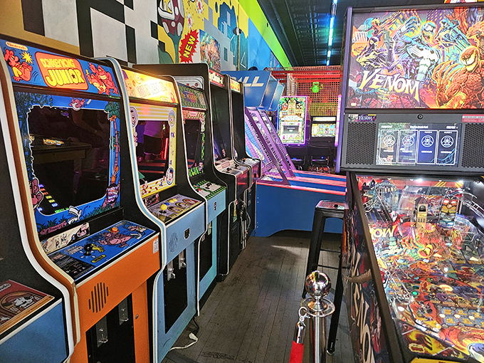 Classic cabinets stand shoulder-to-shoulder like old friends at a reunion. Each one holds stories of quarters spent and high scores achieved.