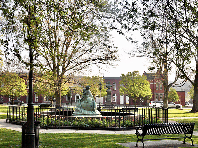 The town green's fountain creates a gathering spot where conversations flow as freely as the water, a social media platform that predates Facebook.