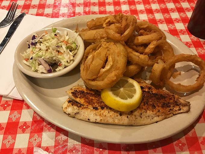 Perfectly grilled fish with a squeeze of lemon, crispy onion rings, and fresh slaw&mdash;proof that Mississippi knows its seafood as well as its meat.