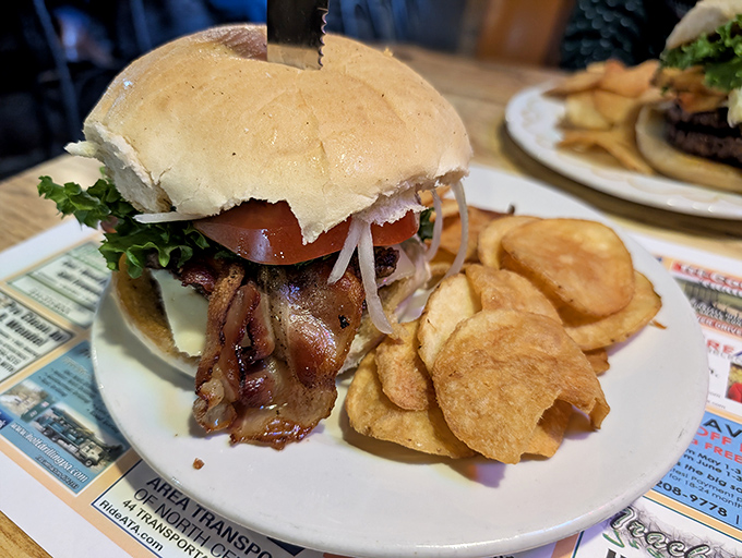 A burger that requires both hands and a strategy. Juicy meat, fresh toppings, and those homemade potato chips &ndash; lunch doesn't get better than this.