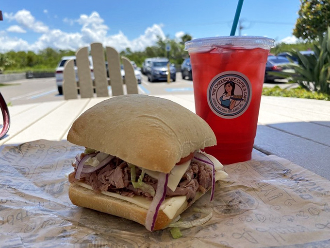 A sandwich that means business, paired with a ruby-red refreshment. Lunch with a view of paradise? Yes, please.