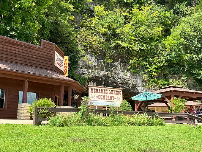 Meramec Caverns' entrance building promises adventure with a side of gift shop souvenirs. The limestone cliff behind holds secrets 400 million years in the making.