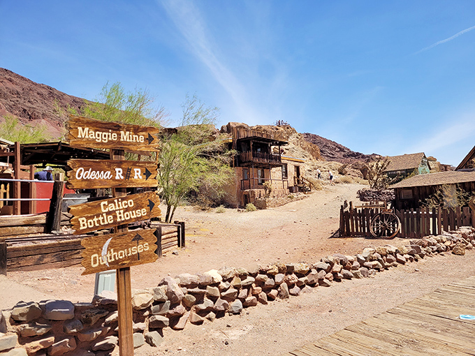 Wooden signposts point the way to Calico's attractions like an analog GPS from another era, promising adventures down each dusty path.