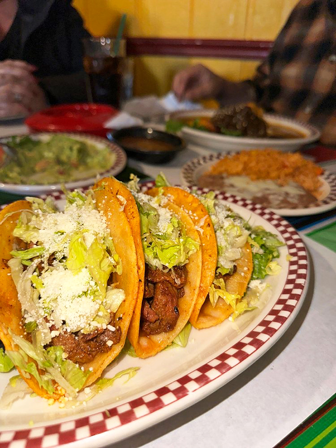 Tacos that respect tradition while making you reconsider your definition of perfection. That sprinkle of cotija cheese is the culinary equivalent of a perfect high note.