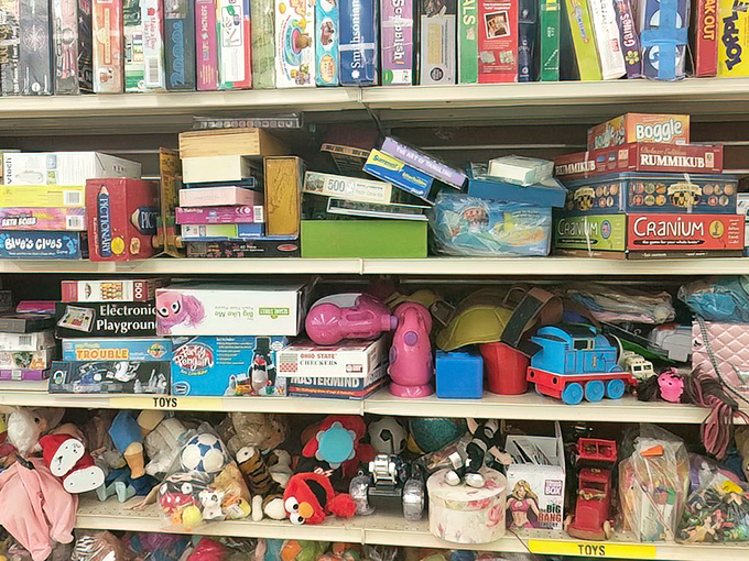 Board games stacked like a Jenga tower of nostalgia. That Electronic Playground might be missing pieces, but childhood memories come complete.