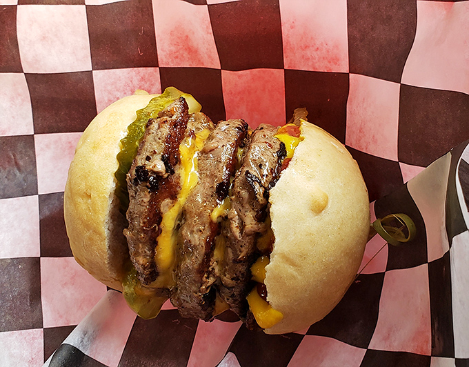 Three sliders stacked with all the fixings &ndash; because sometimes one burger just isn't enough for happiness.