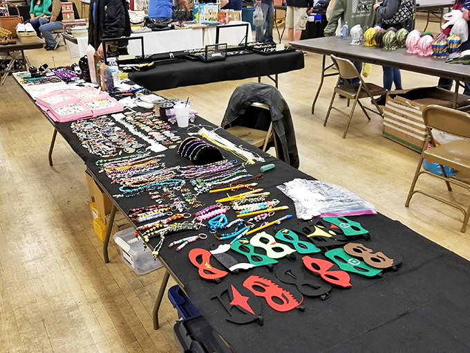 Costume jewelry and masks laid out like a treasure map. The perfect spot to find that conversation piece for your next dinner party. 