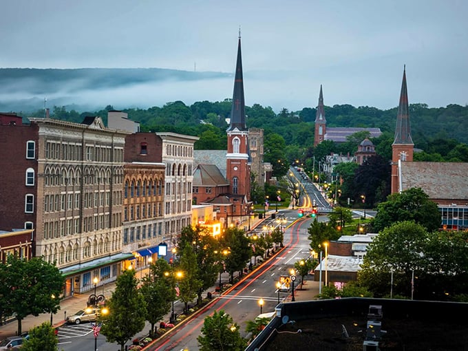 Twilight bathes the main street in golden light, highlighting a community where neighbors still know each other and housing costs remain earthbound.
