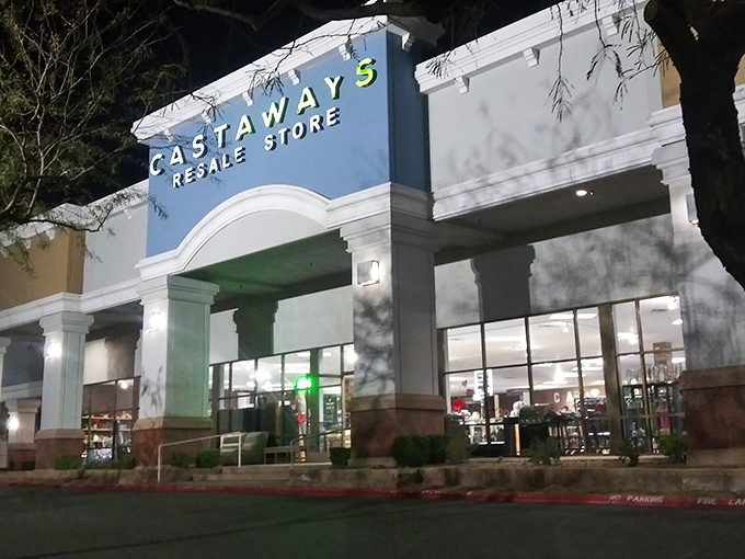 Castaways glows with evening promise, its illuminated sign a beacon for night-owl bargain hunters. Thrifting magic happens here!
