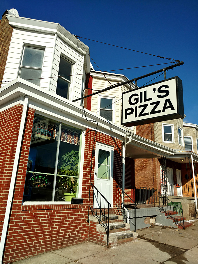 Gil's corner spot plays it cool - that simple hanging sign is the only hint of the pizza magic happening inside this Baltimore rowhouse.
