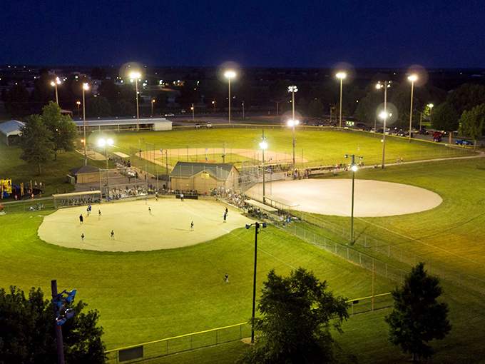 Under the lights, Higginsville's community ballfields become the center of the universe on summer evenings.