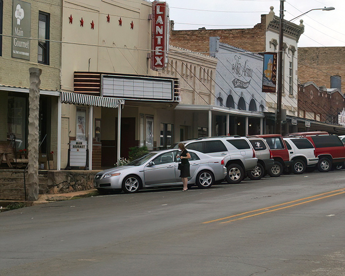 Llano's pink granite courthouse anchors a square where peach season sweetens every summer conversation.
