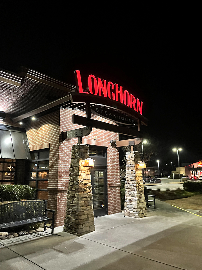 LongHorn's stone pillars and glowing red sign stand ready for the dinner rush. Where urban cowboys find their perfect steak.